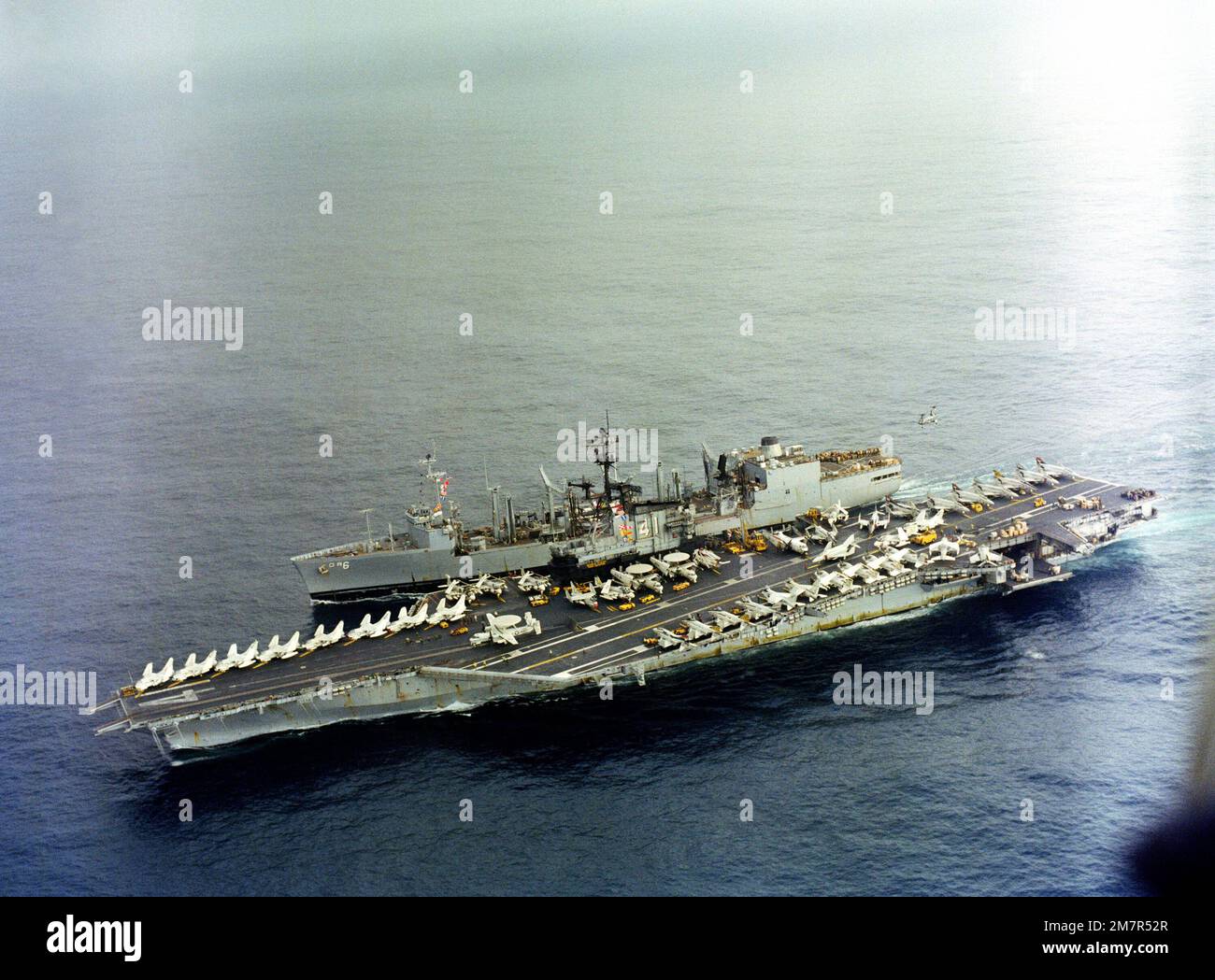 An aerial port view of the aircraft carrier USS MIDWAY (CV 41) and the ...