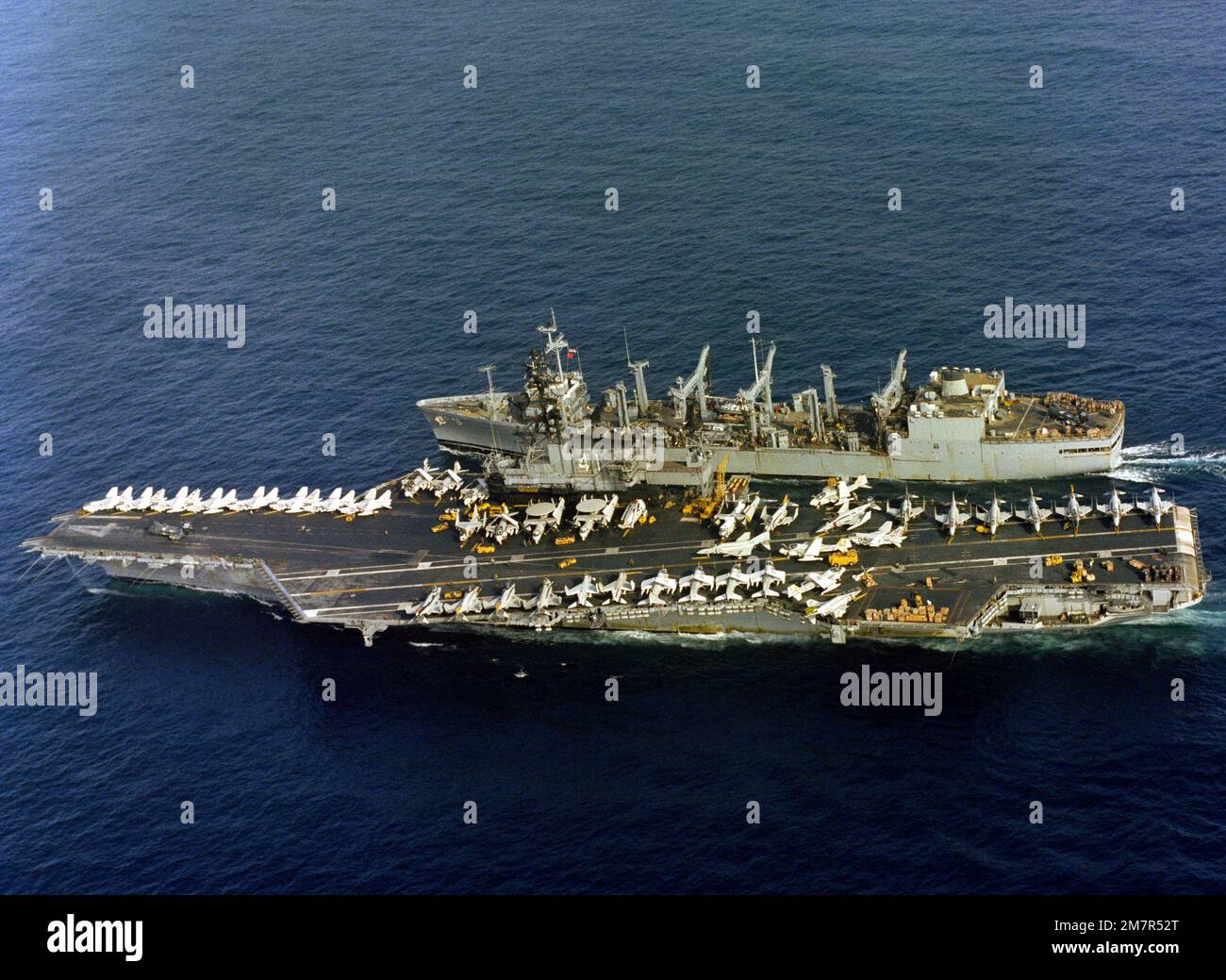 An aerial port beam view of the aircraft carrier USS MIDWAY (CV 41) and ...