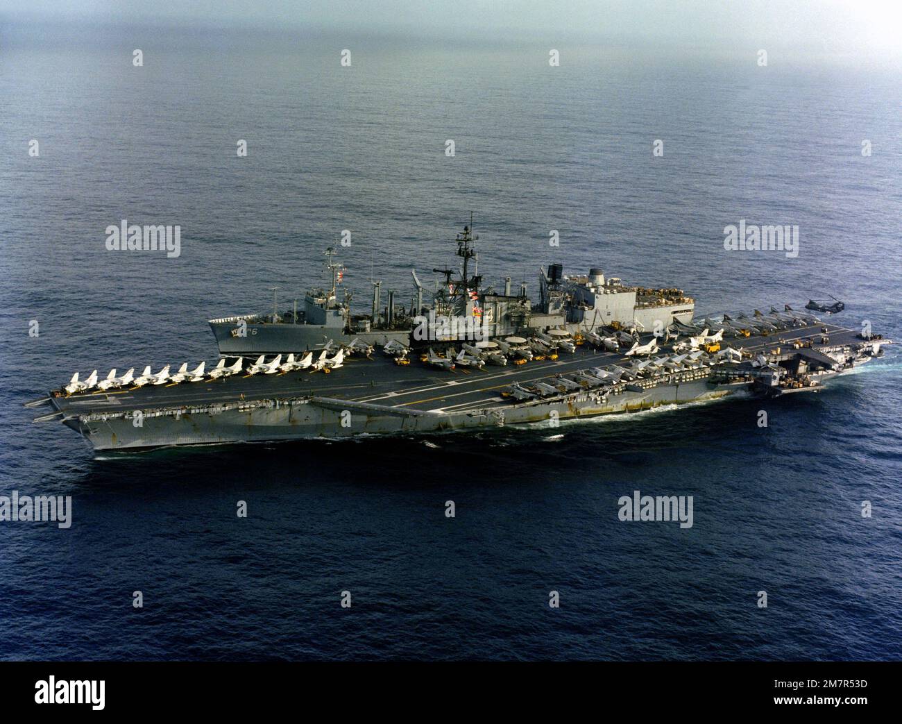 An aerial port view of the aircraft carrier USS MIDWAY (CV 41) and the ...