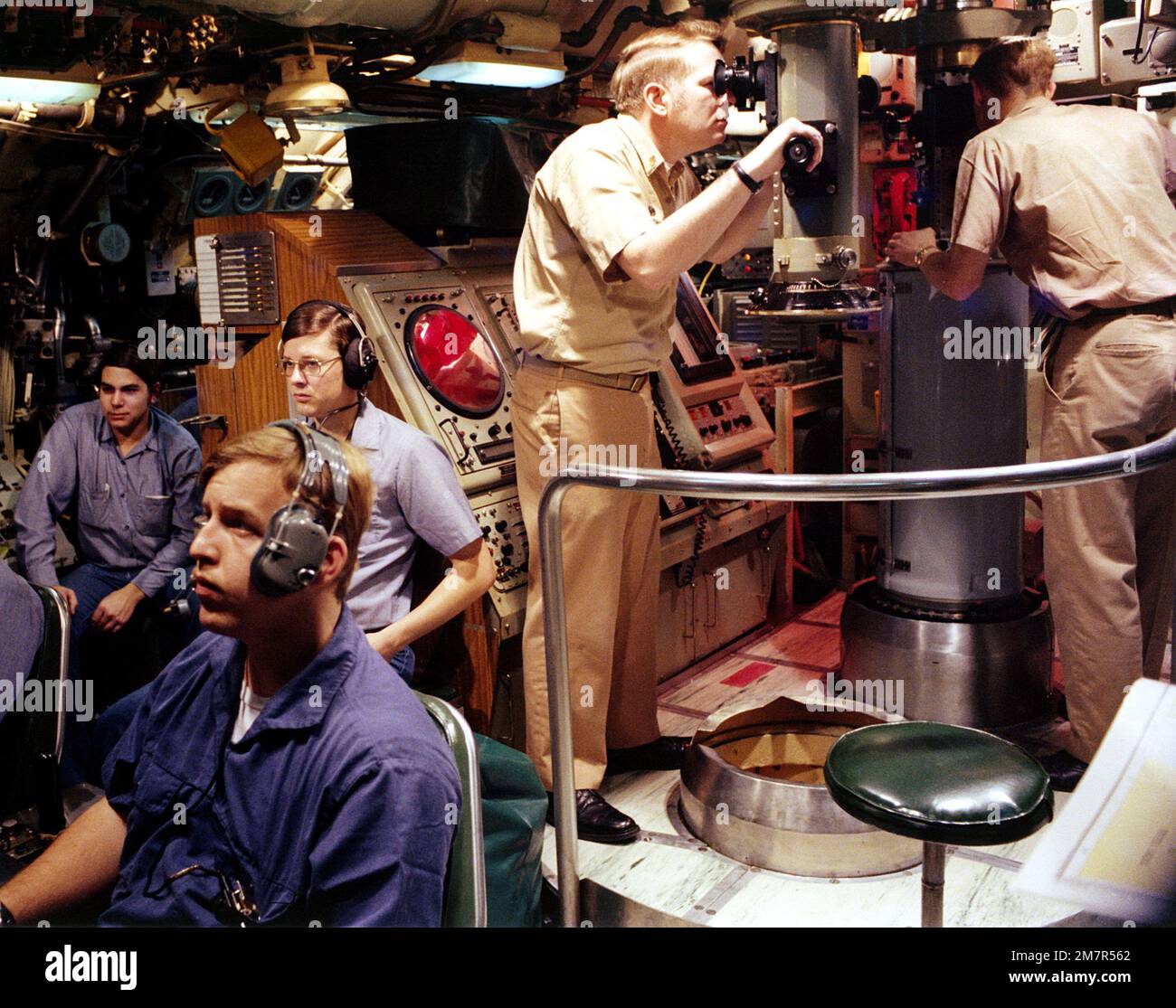 An Officer Aboard A Sturgeon Class Nuclear Powered Attack Submarine Uses The Ships Periscope In