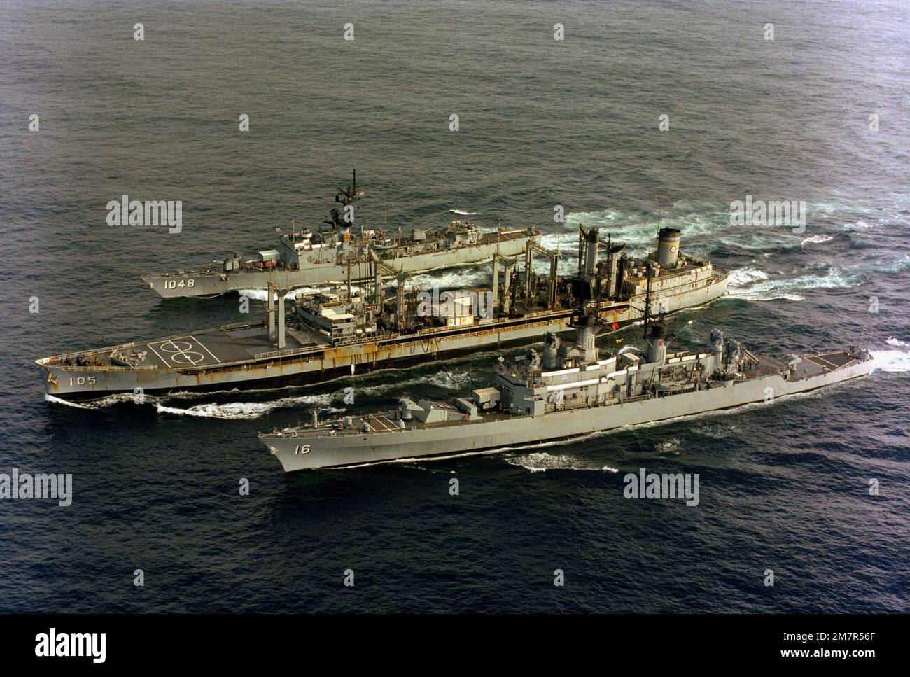 An aerial port view of the oiler USS MISPILLION (AO 105), center ...