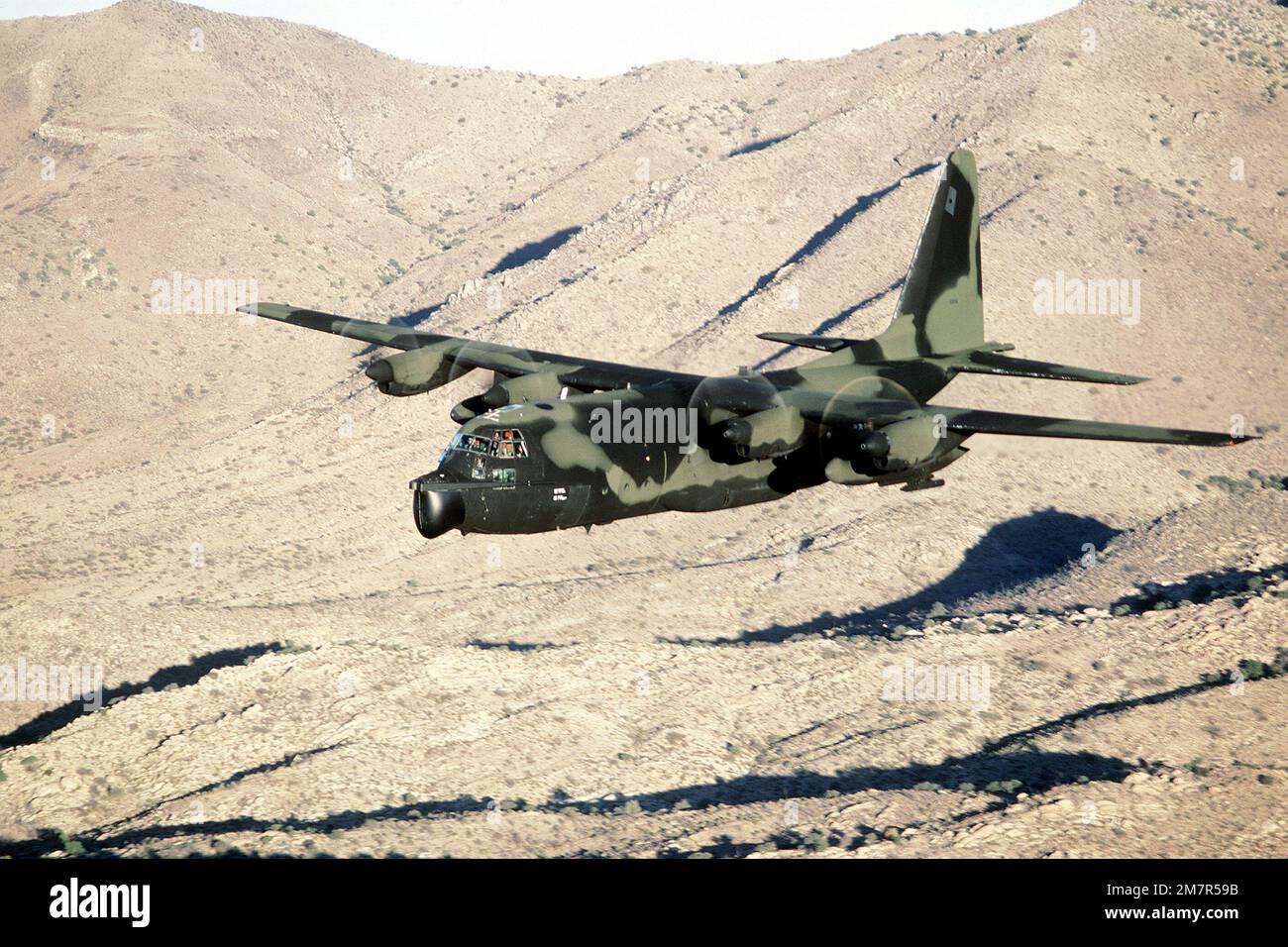 AN air-to-air front view of an MC-130E Hercules aircraft flying low ...