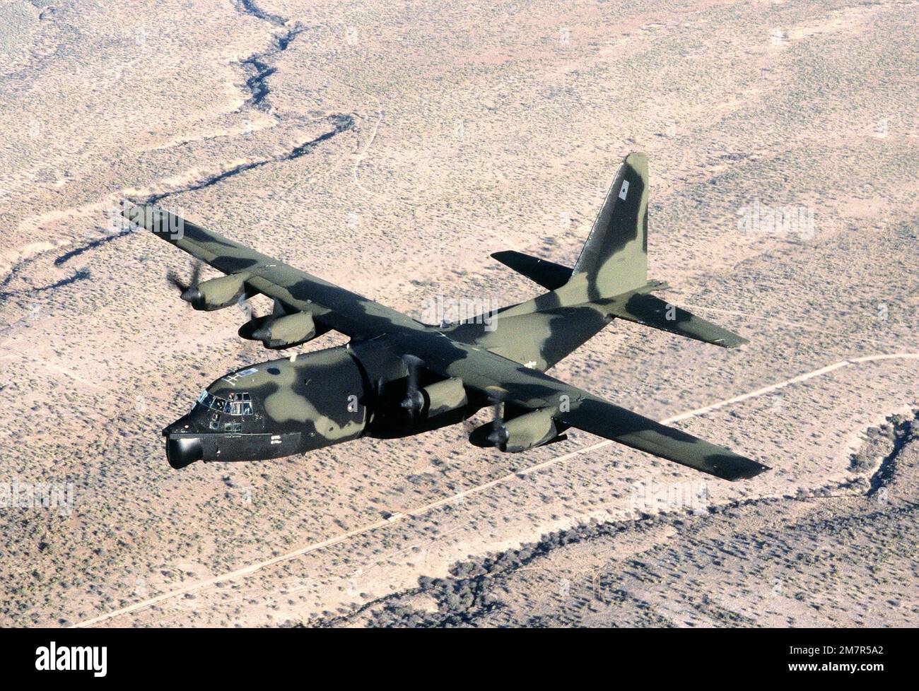 AN air-to-air view of an MC-130E Hercules aircraft flying low-level ...
