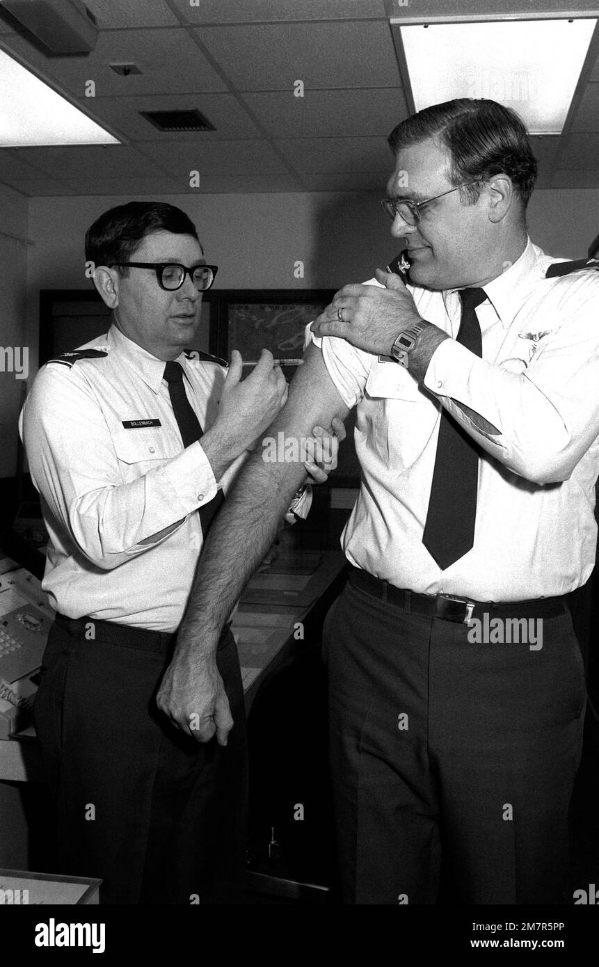 COL Merle E. Bollenbach, base commander, administers the first flu ...