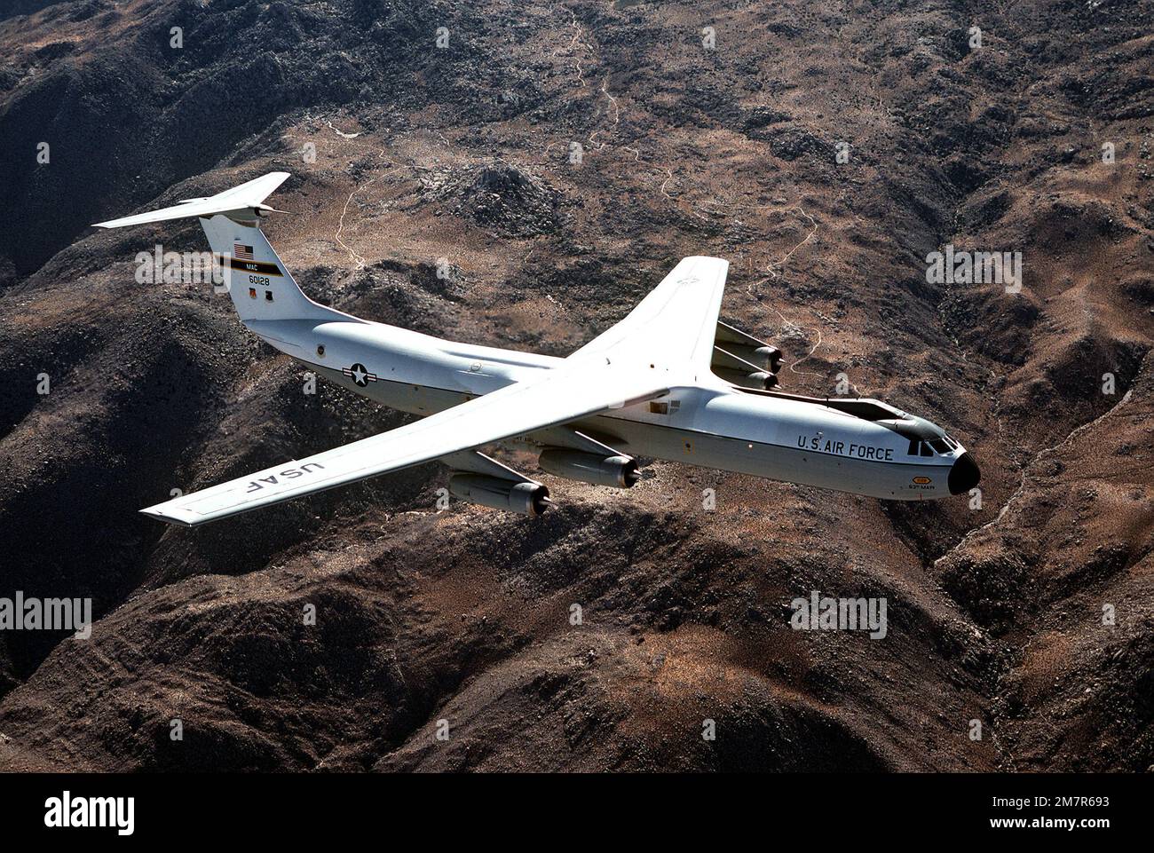 AN air-to-air right side view of a C-141B Starlifter aircraft over ...