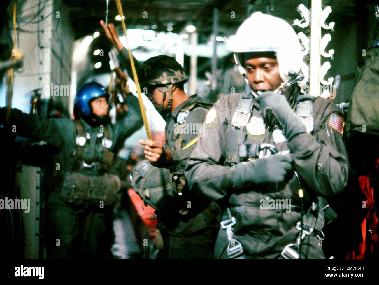 A 374th Tactical Airlift Wing loadmaster coordinates with the pilot as ...
