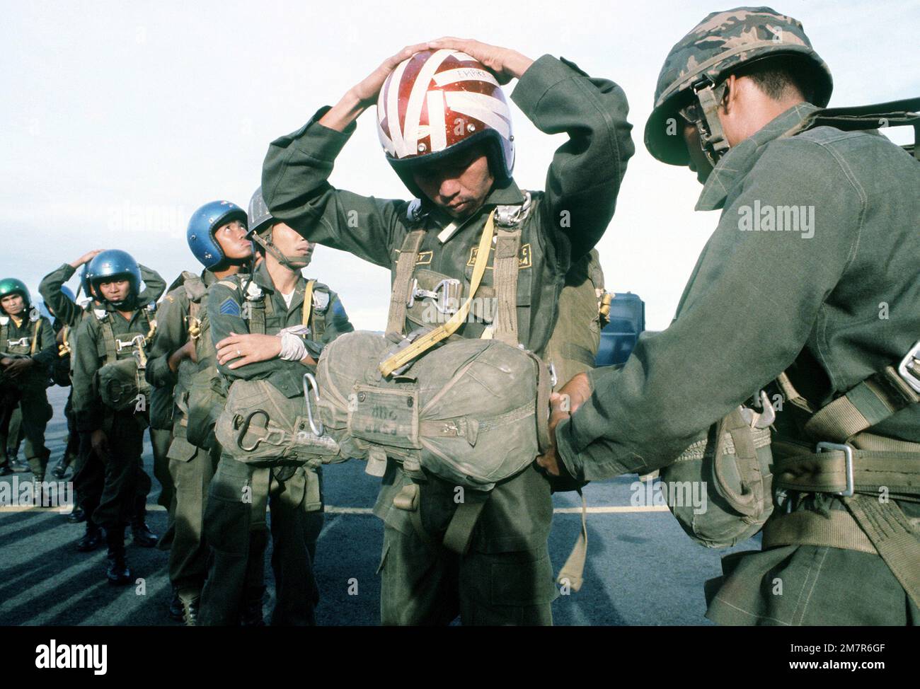 Philippine army paratroopers have their equipment checked by a ...