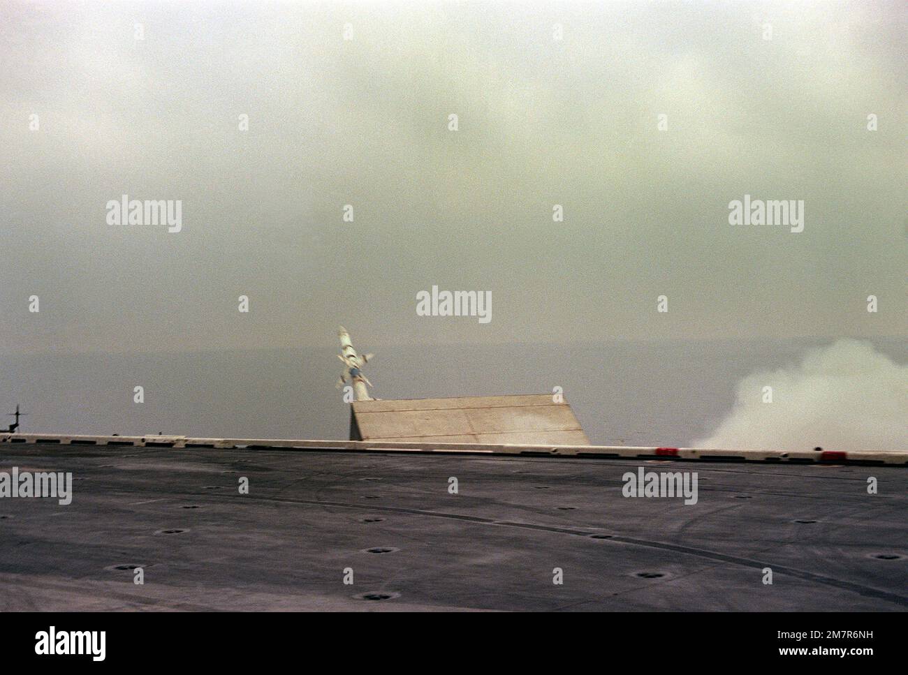 An RIM-7 Sparrow missile emerges from its Mark 25 launcher during a ...
