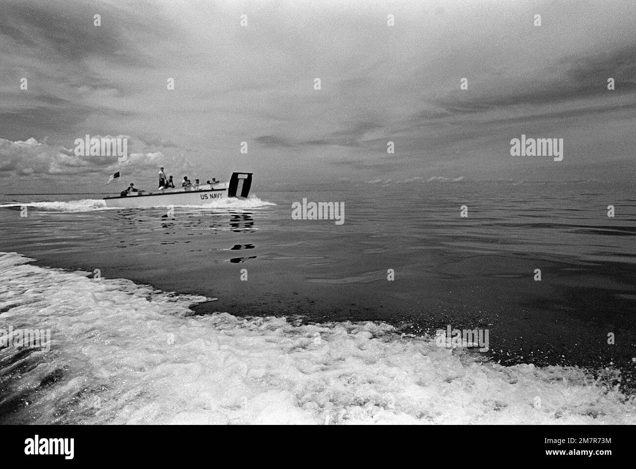 A Navy landing craft, vehicle and personnel (LCVP), heads back to the ...