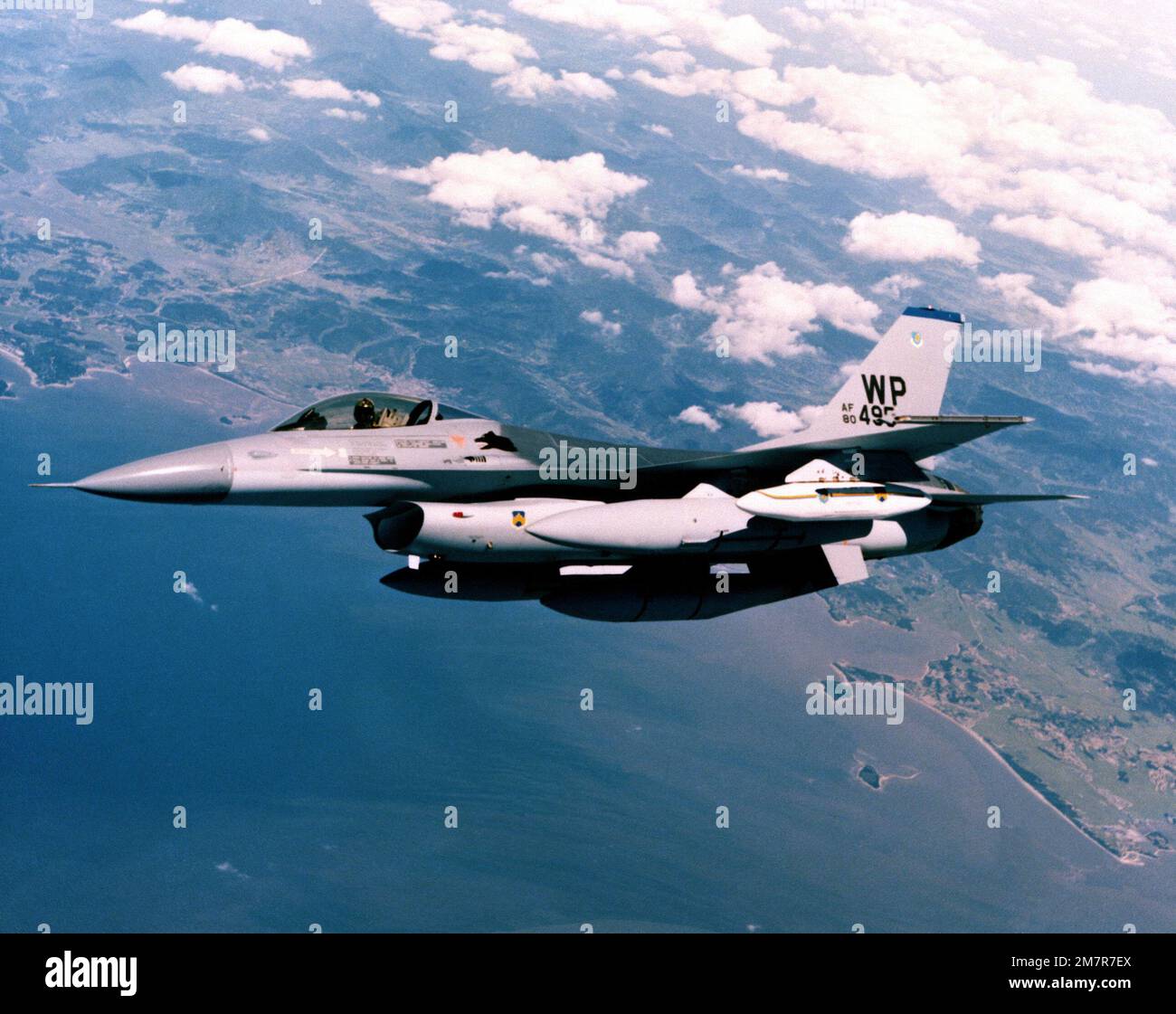 A view of an F-16A Fighting Falcon aircraft banking to the right during ...