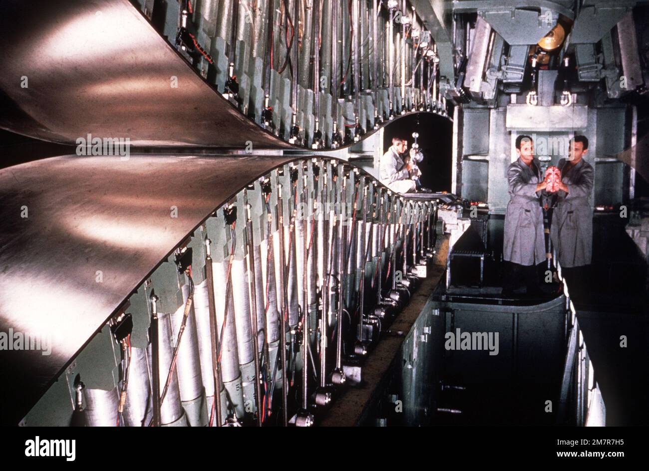 A supersonic wind tunnel with side wall removed to show flexible plate ...