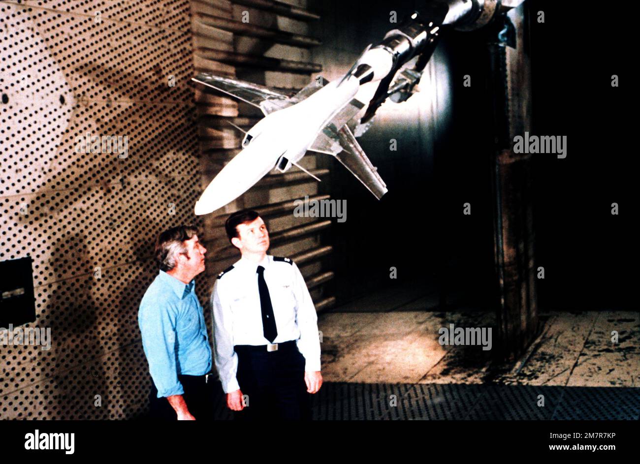 Technicians discuss a scale model of an advanced forward-swept wing ...