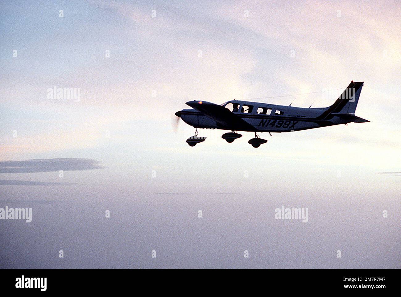 Left side view of a Piper Arrow aircraft, silhouetted against the ...