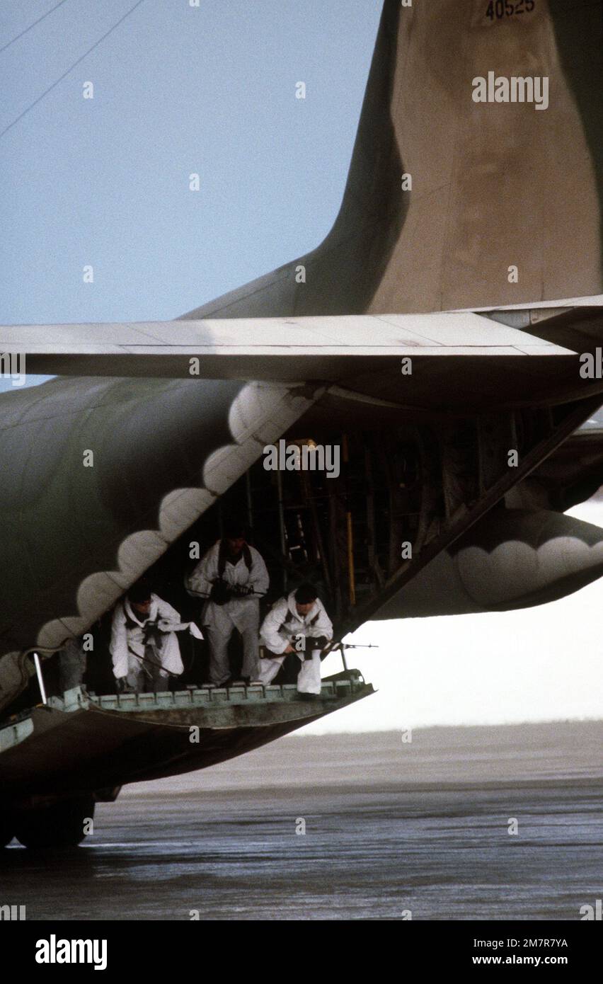 Green Berets scurry from a C-130 Hercules aircraft during a practice ...