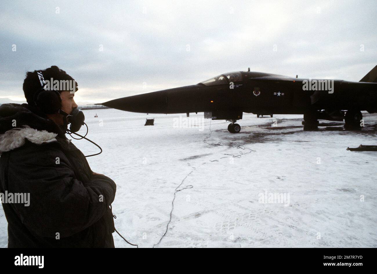 A flight line crewman talks to an FB-111A pilot before the aircraft is ...