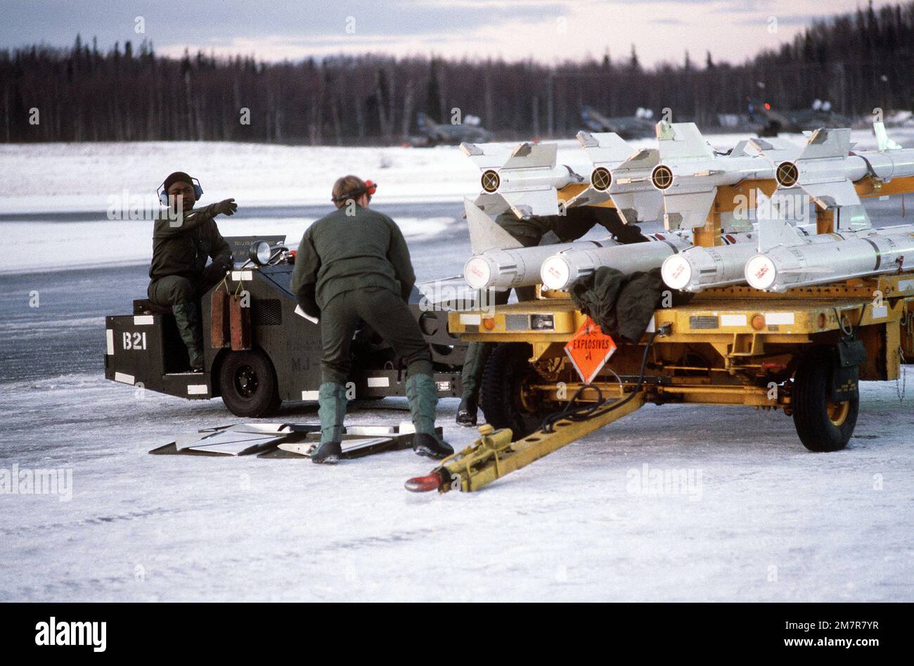 Airmen use a bomb loader to lift an AIM-7 Sparrow air-to-air missile ...