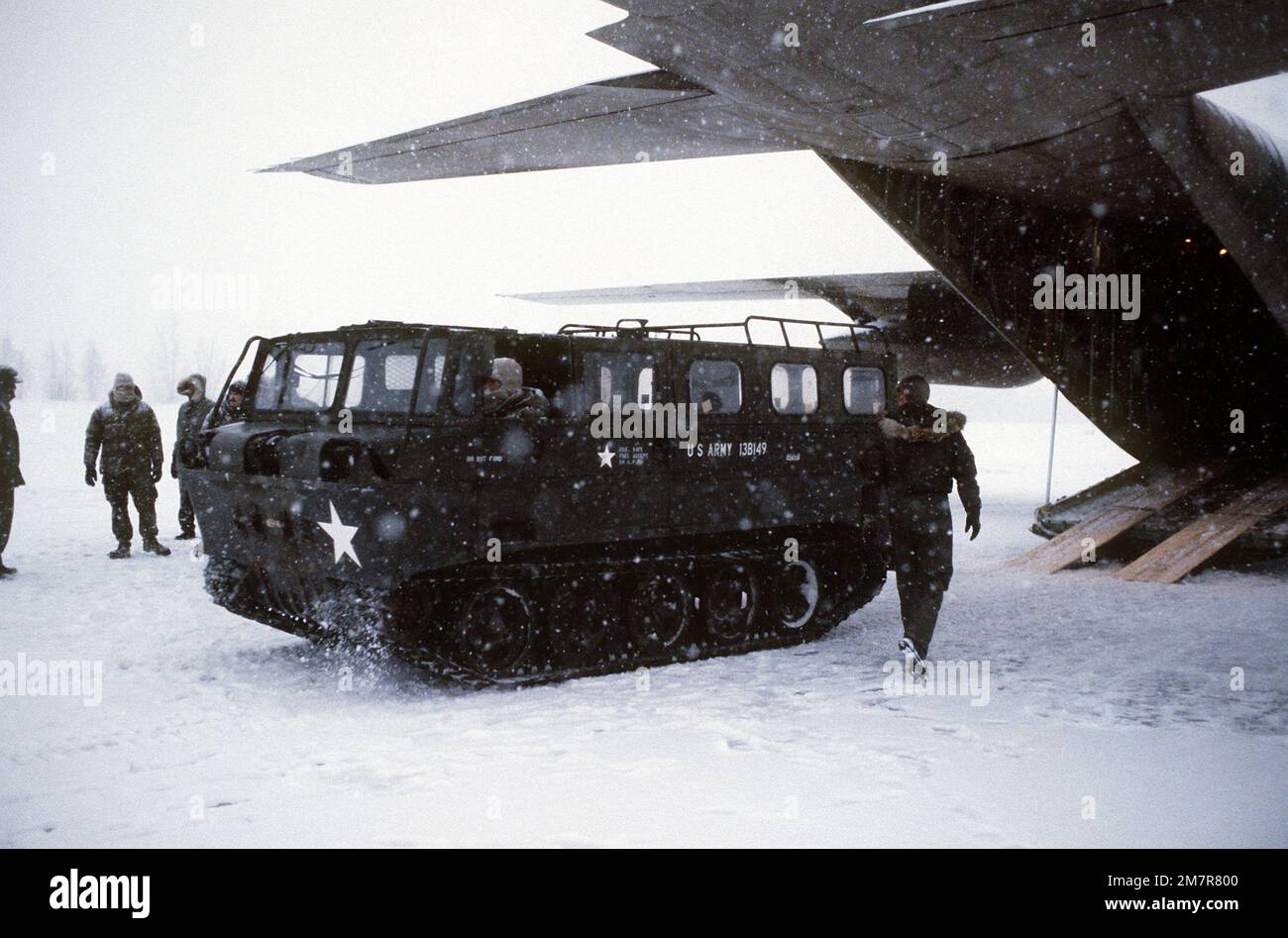 Green Beret troops move a tracked personnel carrier, called a Snow Cat ...