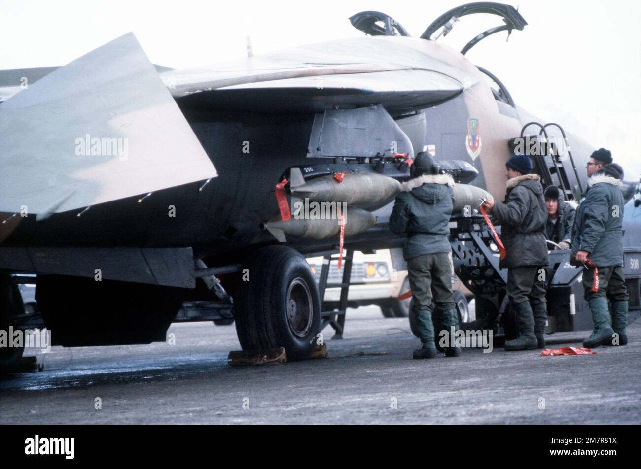 Airmen load Mark 82 500-pound laser-guided bombs on an F-111A aircraft ...