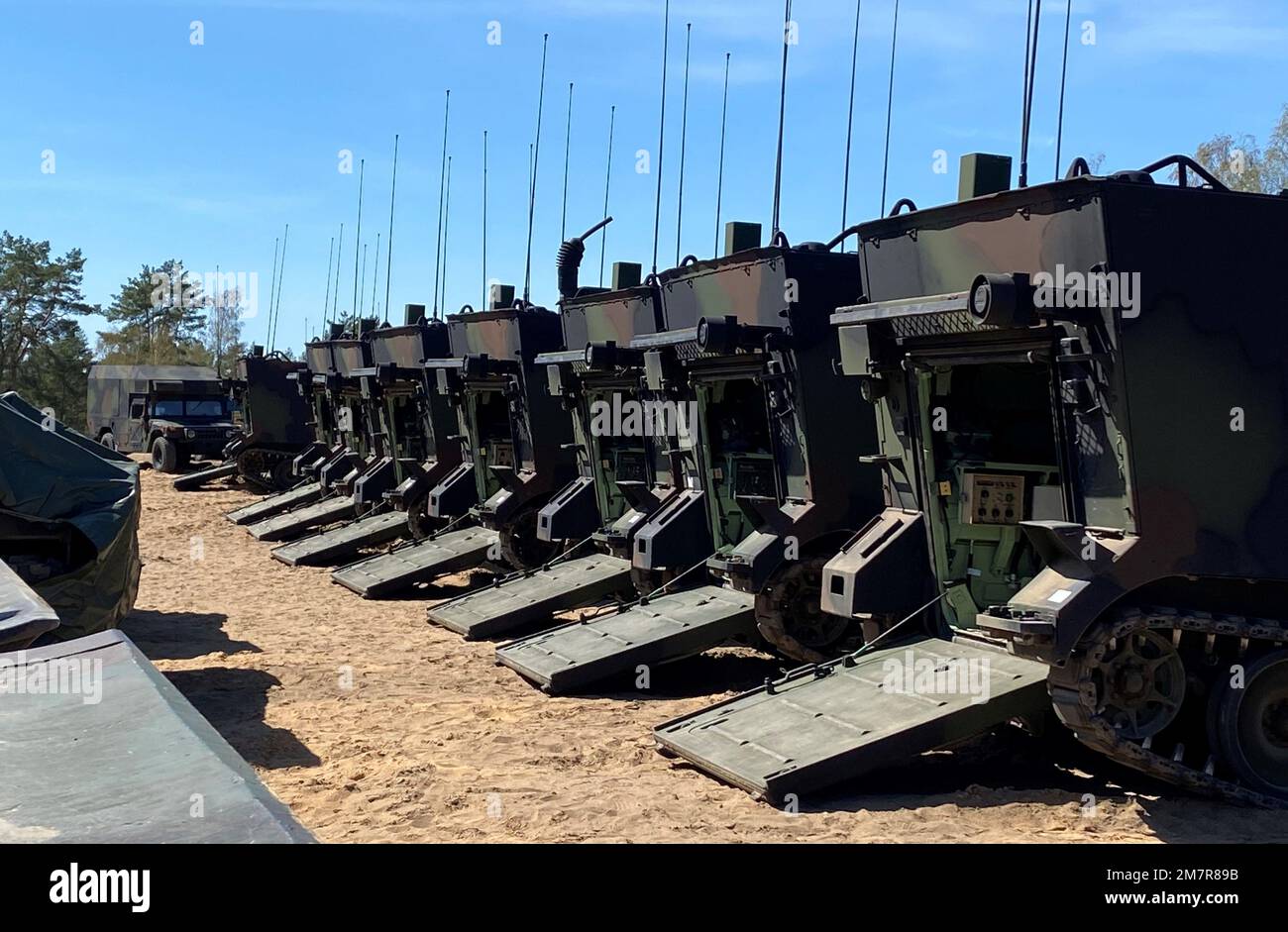 A line of M1068 command post armored vehicles is prepared and ready for ...