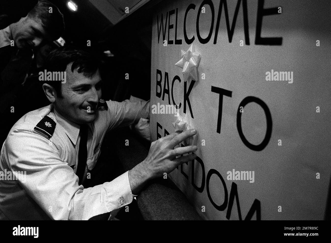 Aeromedical evacuation squadron members post a welcome-home sign, in a ...