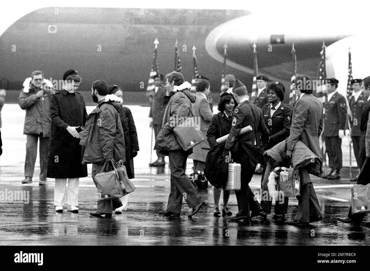 Former hostages are bid farewell by base personnel upon their departure ...