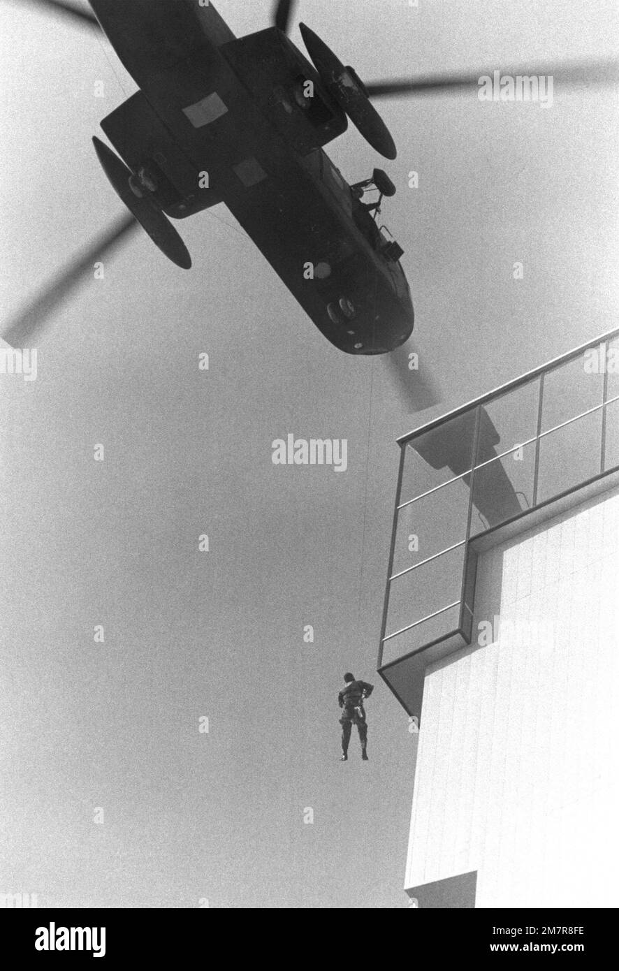 TSGT Jerry Fletcher is lowered from a hovering CH-3E Jolly Green Giant ...