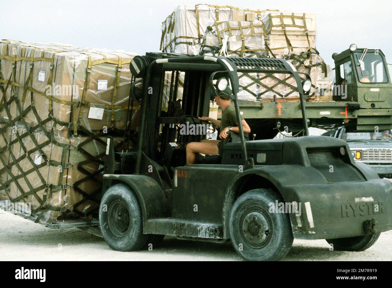 A side view of a forklift carrying cargo pallets during Airlift ...