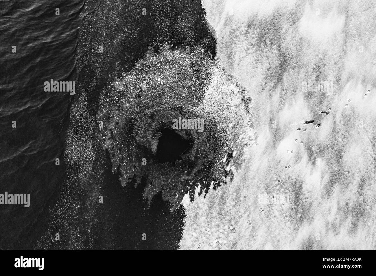 Drone view. Abstract form created on surface of freezing lake, traces ...