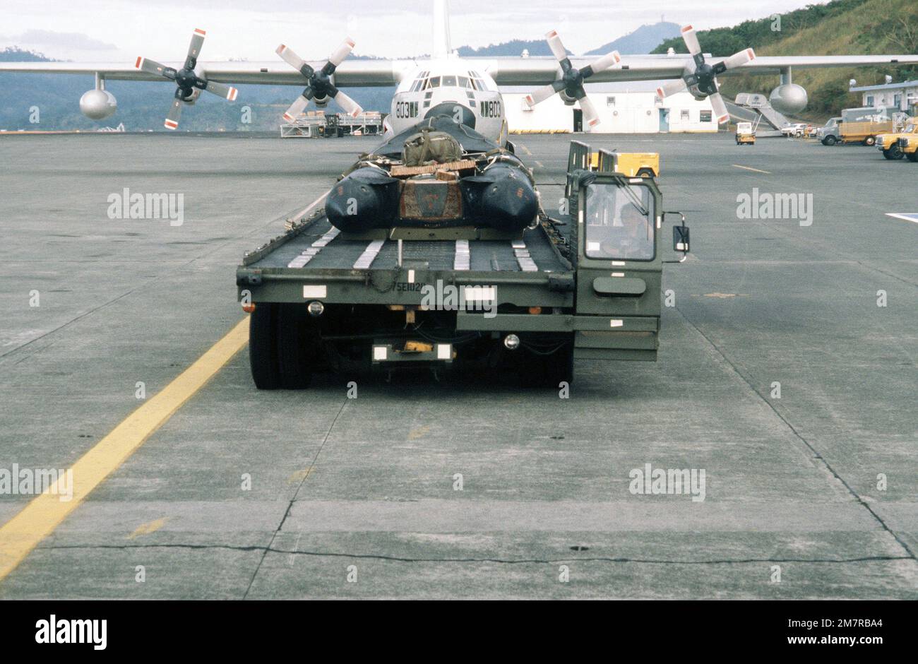 Preparations are made to load a fully outfitted rubber raft aboard a C ...