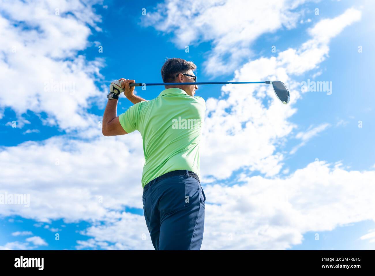 Detail of a golf player on a professional golf course hitting the ball ...