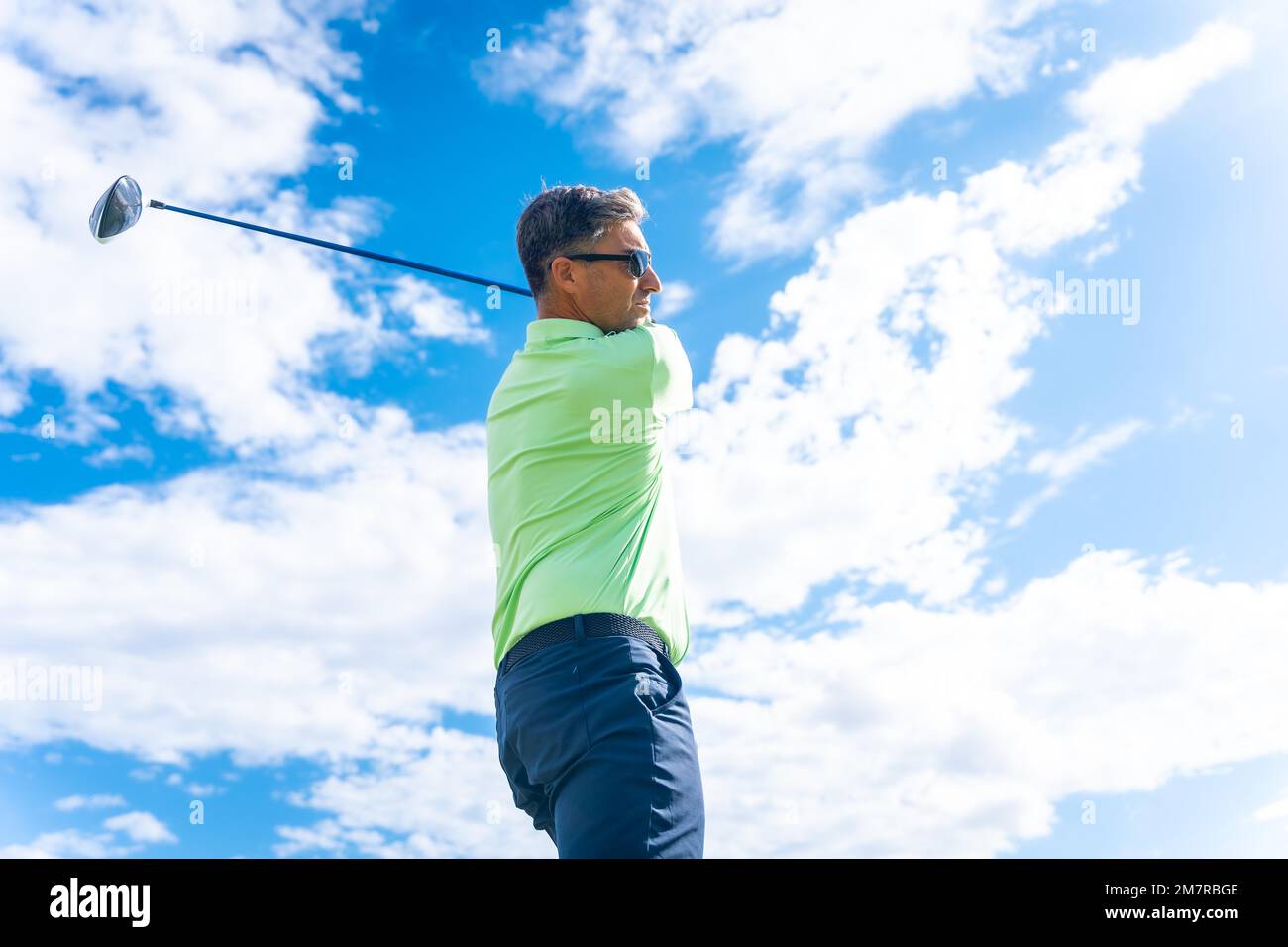 Detail of a golf player on a professional golf course hitting the ball ...