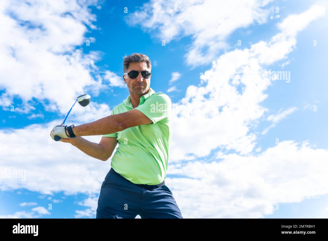 Male golf player on professional golf course hitting the ball with the ...
