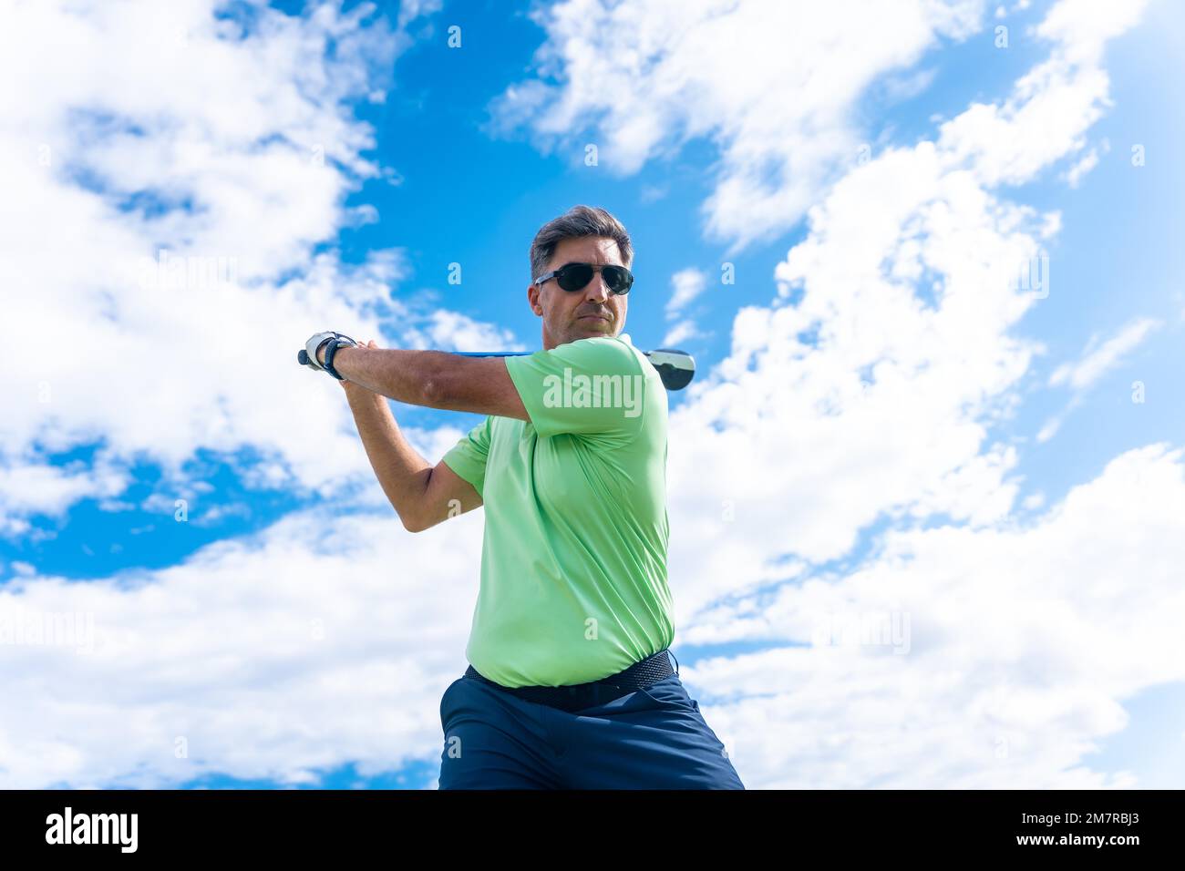 Male golf player on professional golf course hitting the ball with the ...
