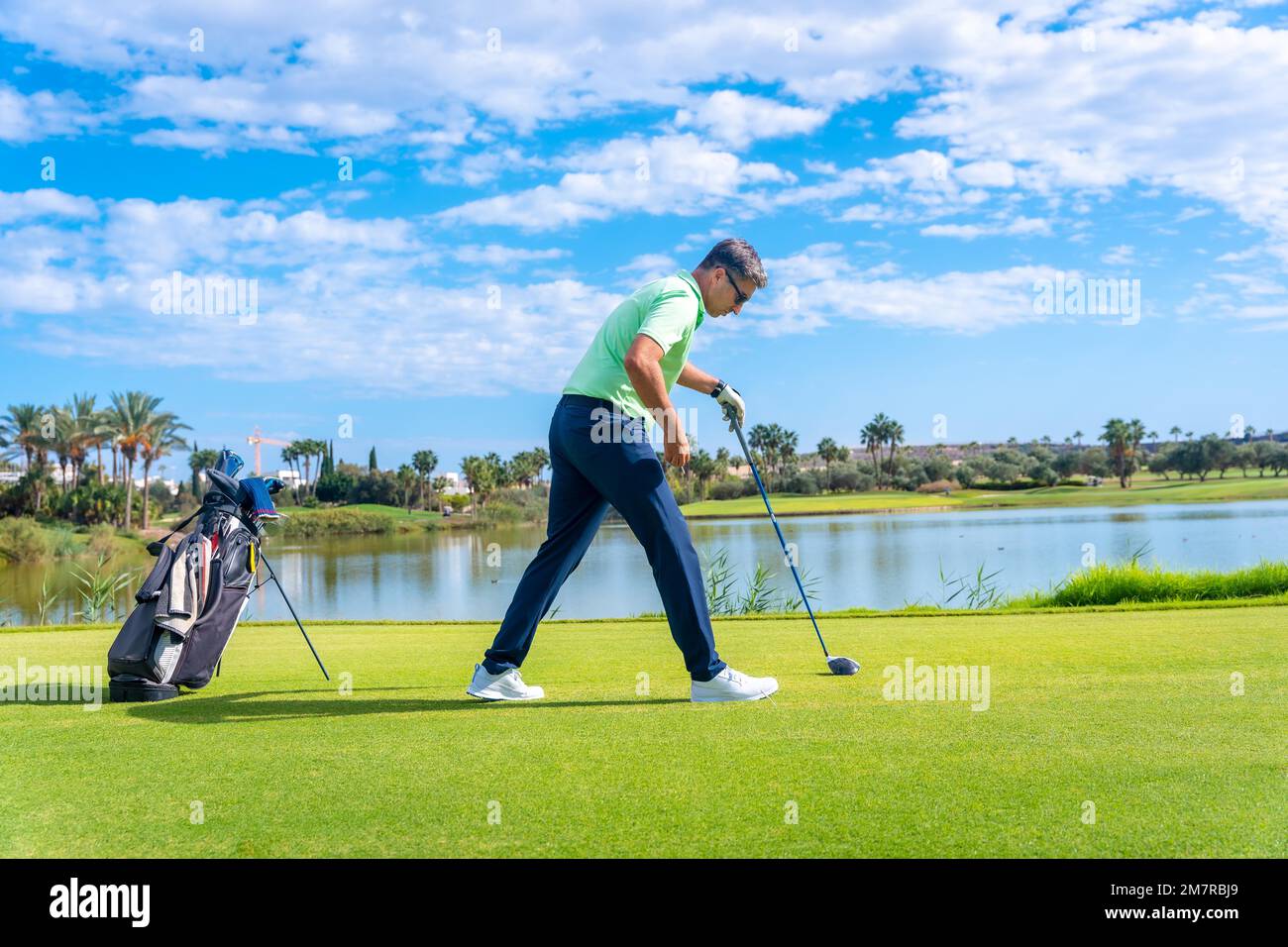 Male golf player on professional golf course. Golfer with golf driver ...