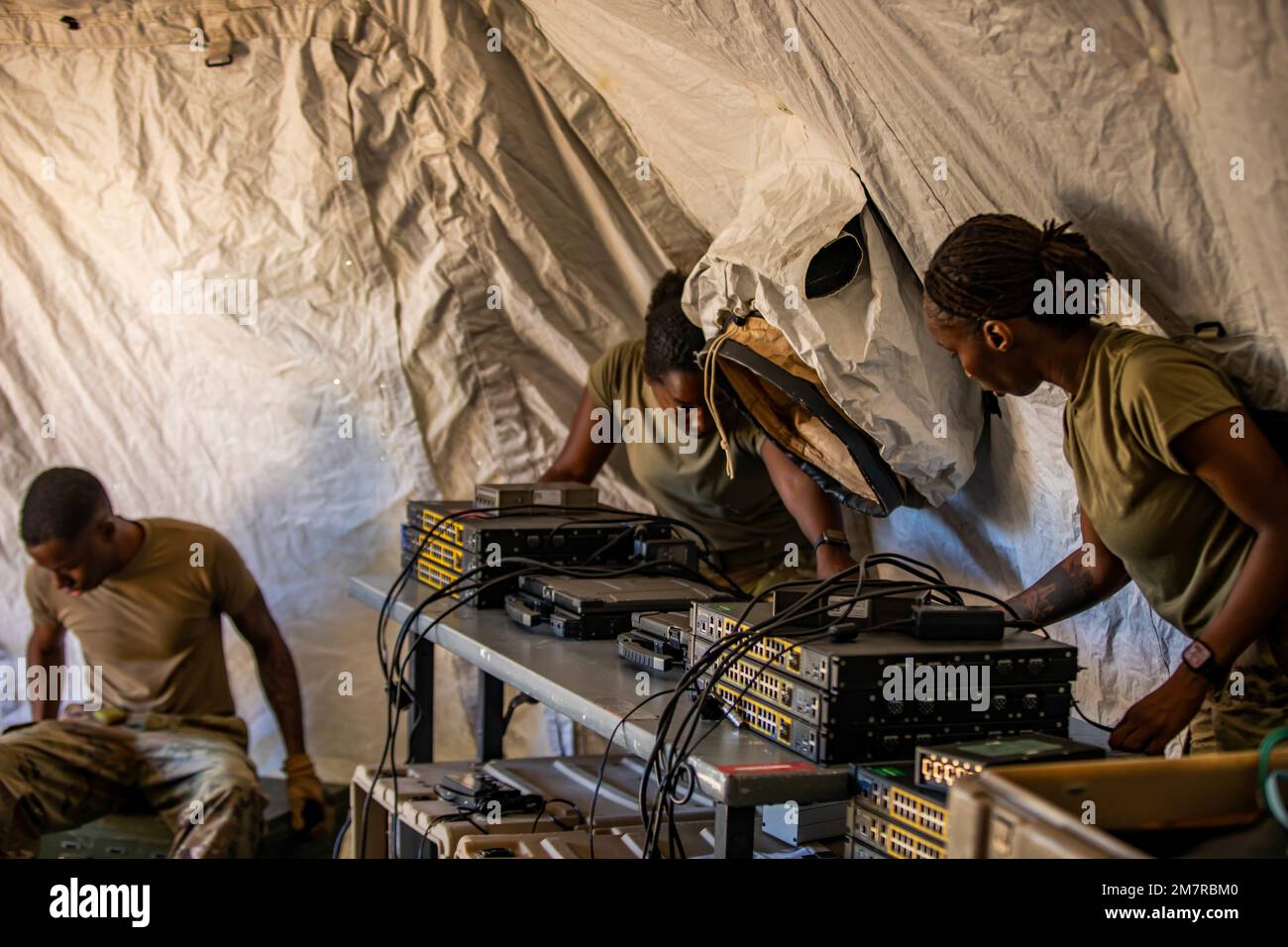 U.S. Army Soldiers assigned to 56th Signal Batallion set up switches ...