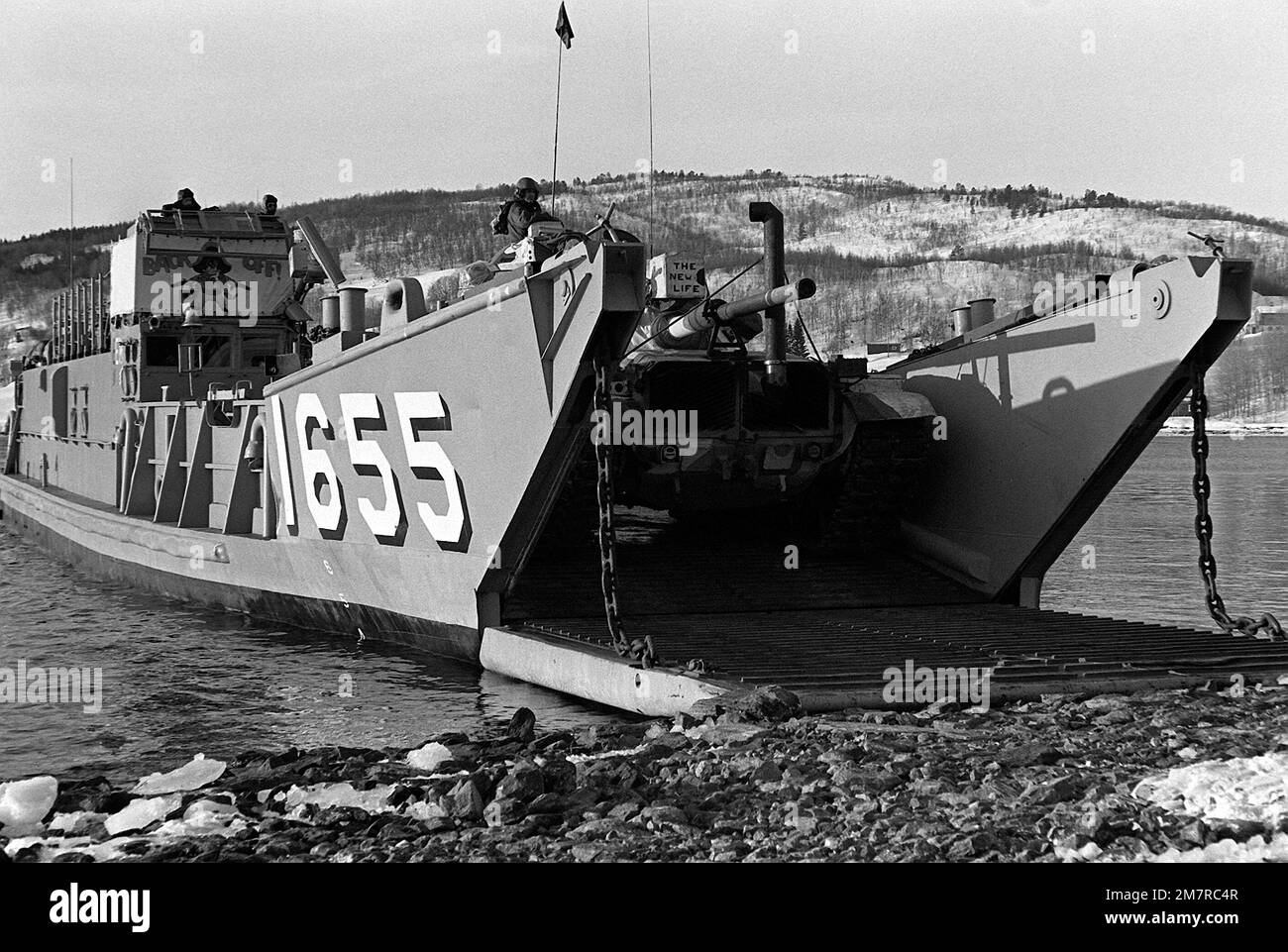 An M-60A1 tank is driven off an LCM-8 mechanized landing craft (LCM-8 ...