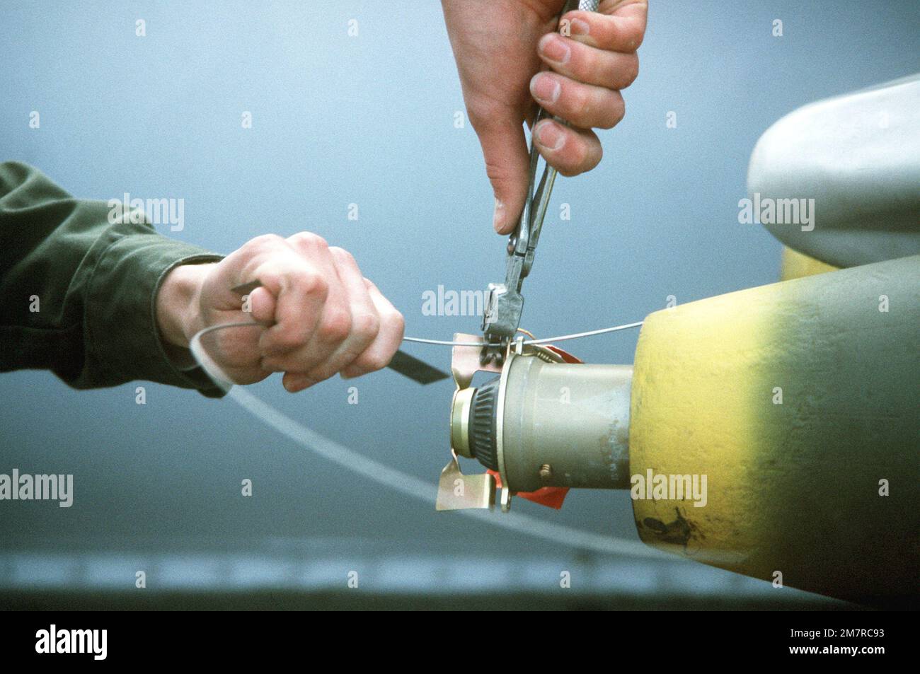 A Mark 82 bomb is wired for safety after being loaded aboard an F-16 ...