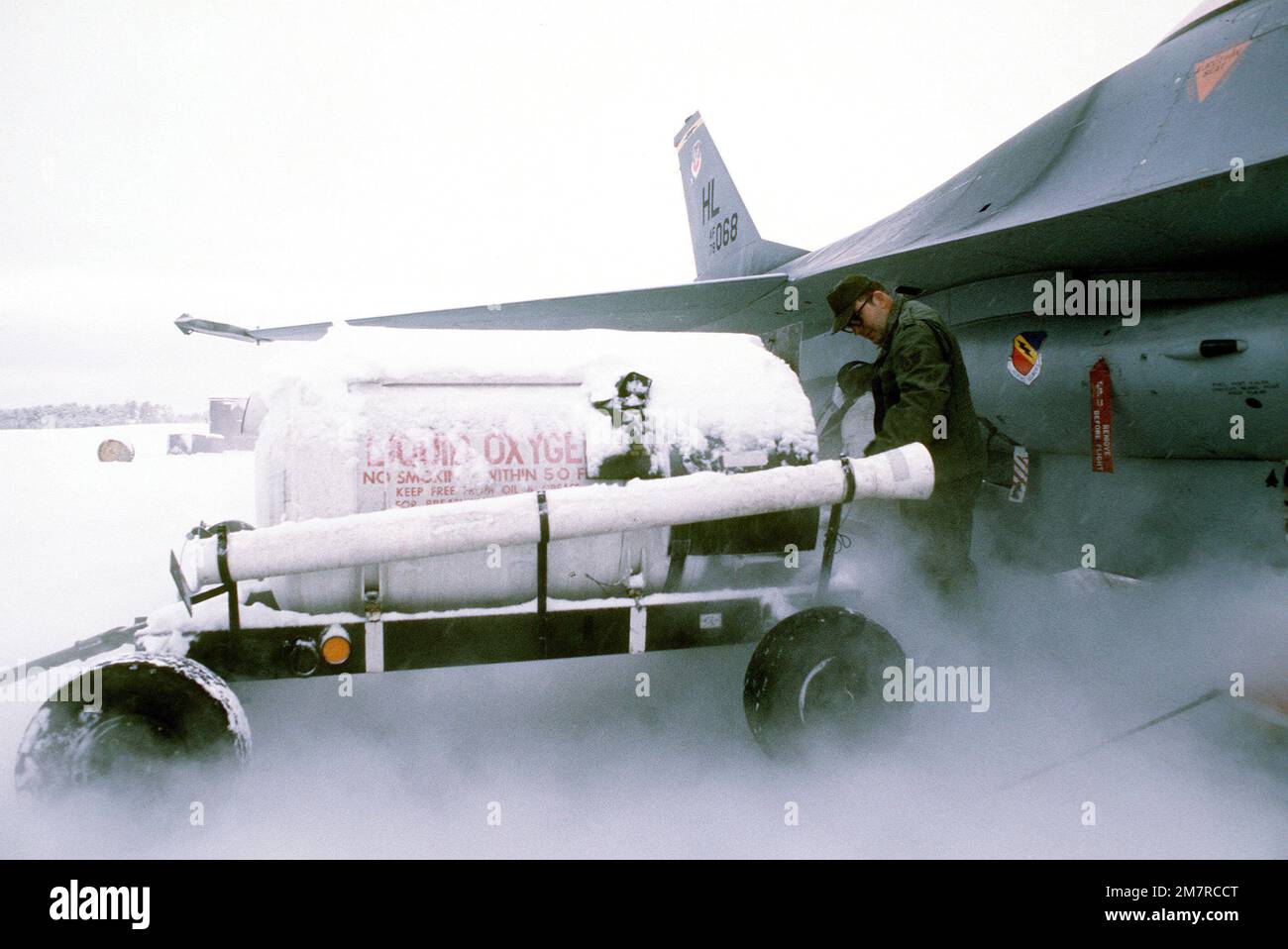 Liquid oxygen is loaded aboard an F-16 Fighting Falcon aircraft from ...