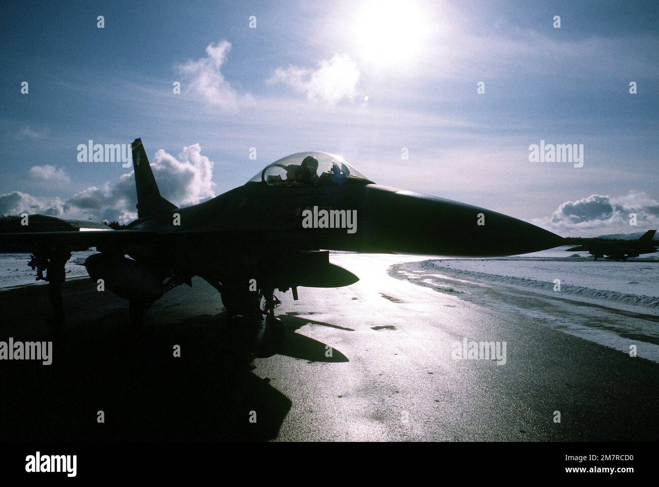 A right front view of an F-16 Fighting Falcon aircraft as it is checked ...
