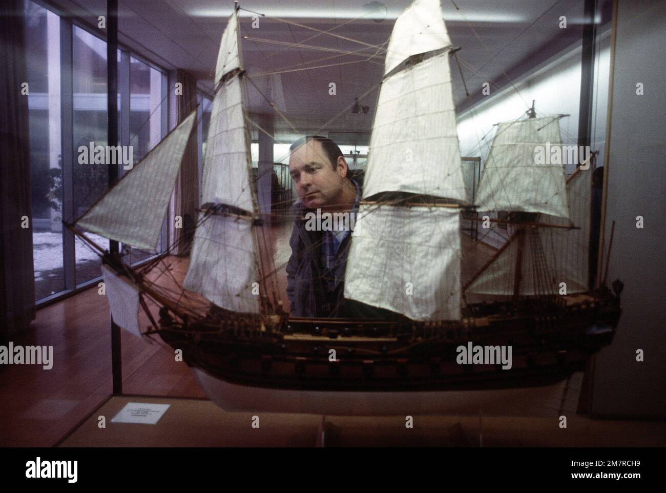 TSGT Wes Gentry, a motion picture cameraman, looks at a ship model at a ...