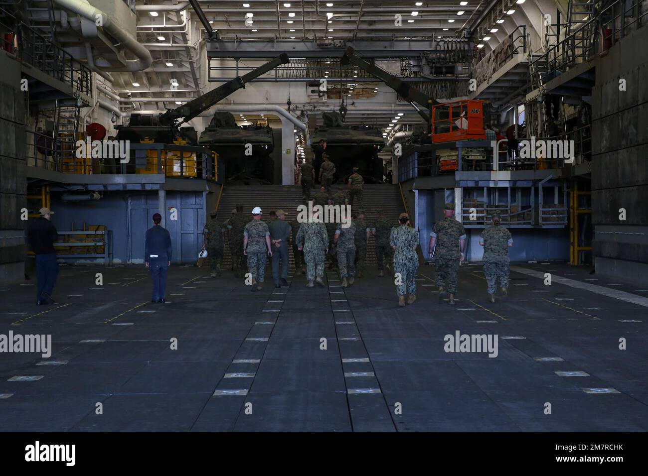 U.S. Marines and sailors walk up the well deck of USS Portland (LPD-27 ...