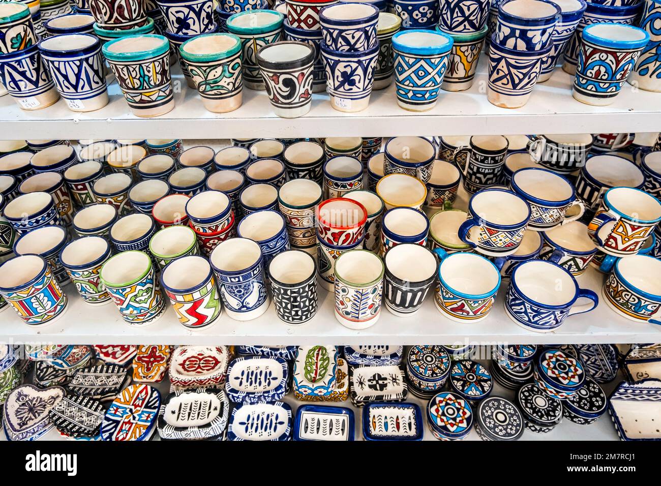 Shelves full of handmade ceramic products in pottery factory in Fez ...