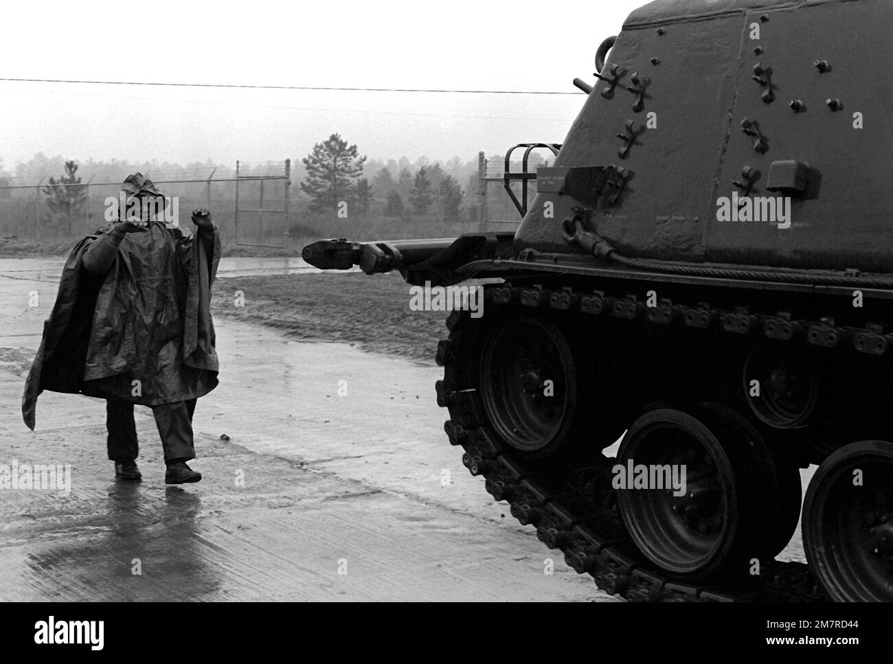 PFC. James Graham guides an M-88 medium recovery vehicle to a parking ...