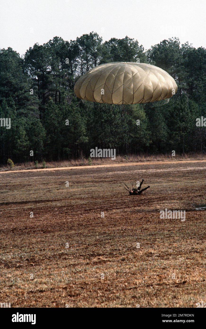 An Air Force Reserve flight surgeon descends after jumping from a C-141 ...