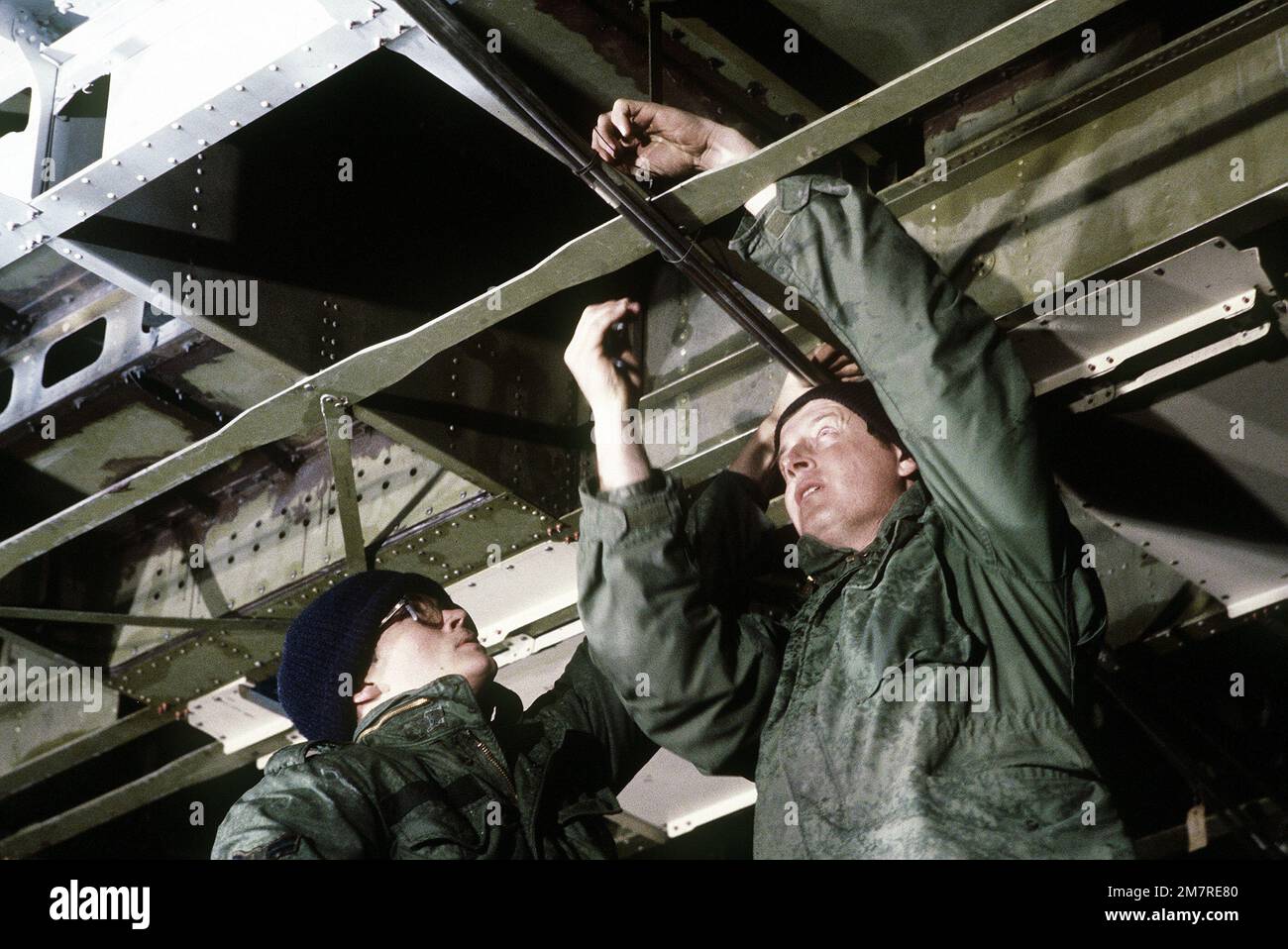 TSGT Gary A. Parker ties up hydraulic lines around the interior of a C ...