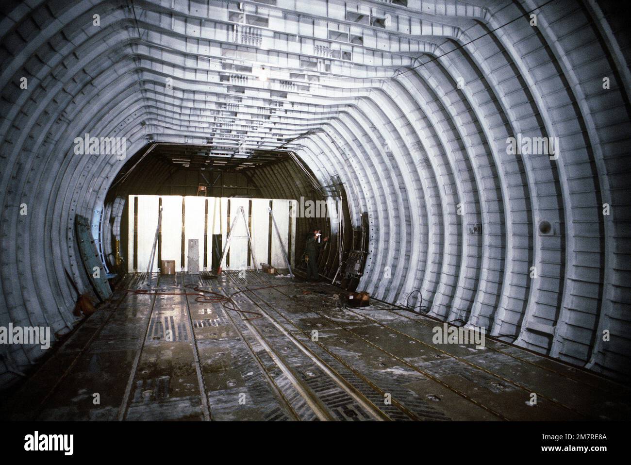 SGT Coleman L. Seaborn spray paints the interior wall of a C-5A Galaxy ...