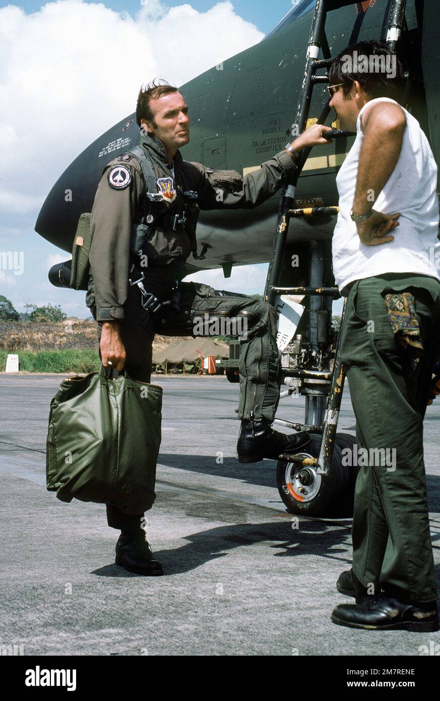 MAJ Strangler, an F-4 Phantom II aircraft pilot, speaks to his crew ...
