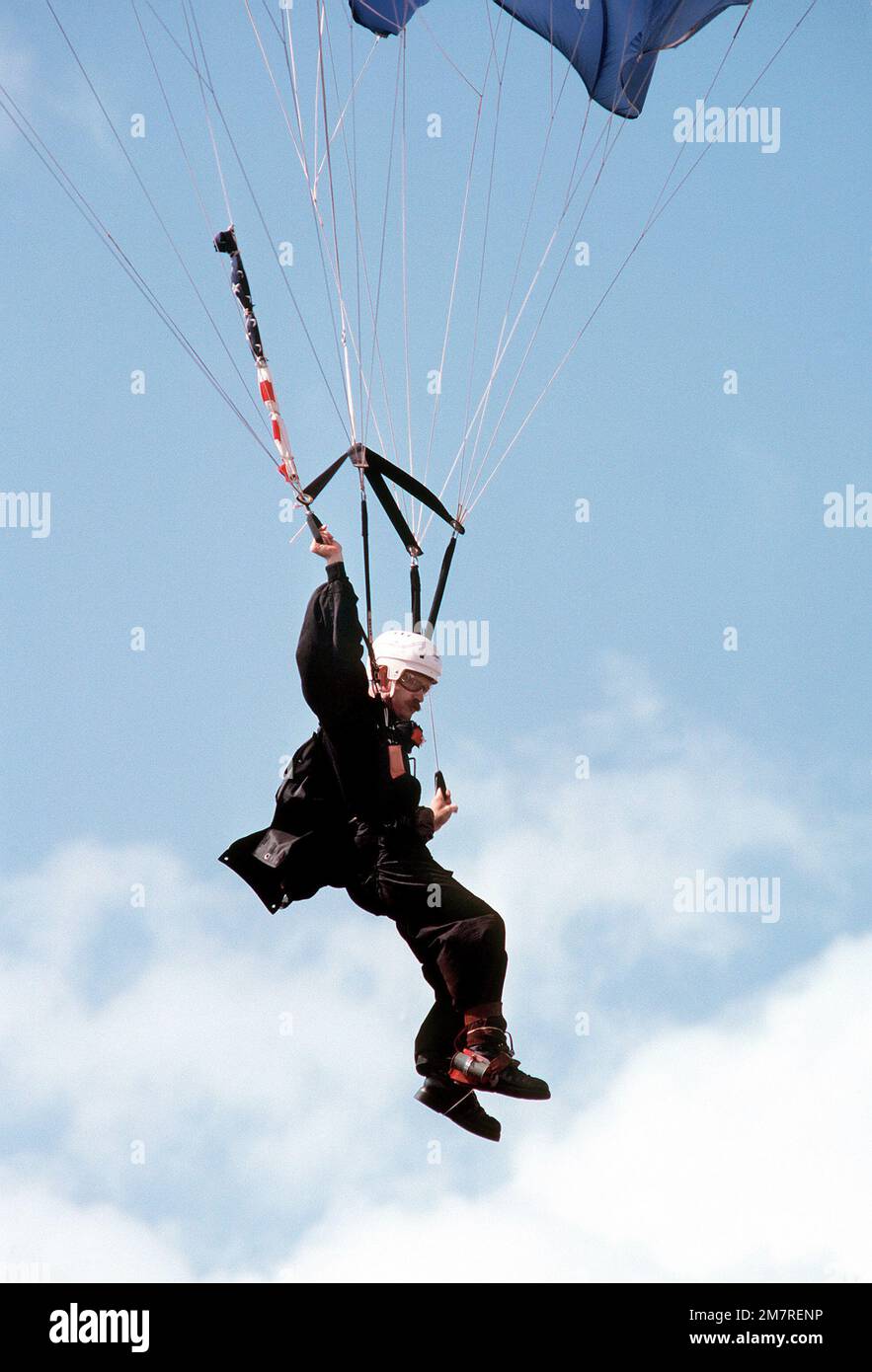 A member of the 193rd Command Parachute Team displays his skill in a ...