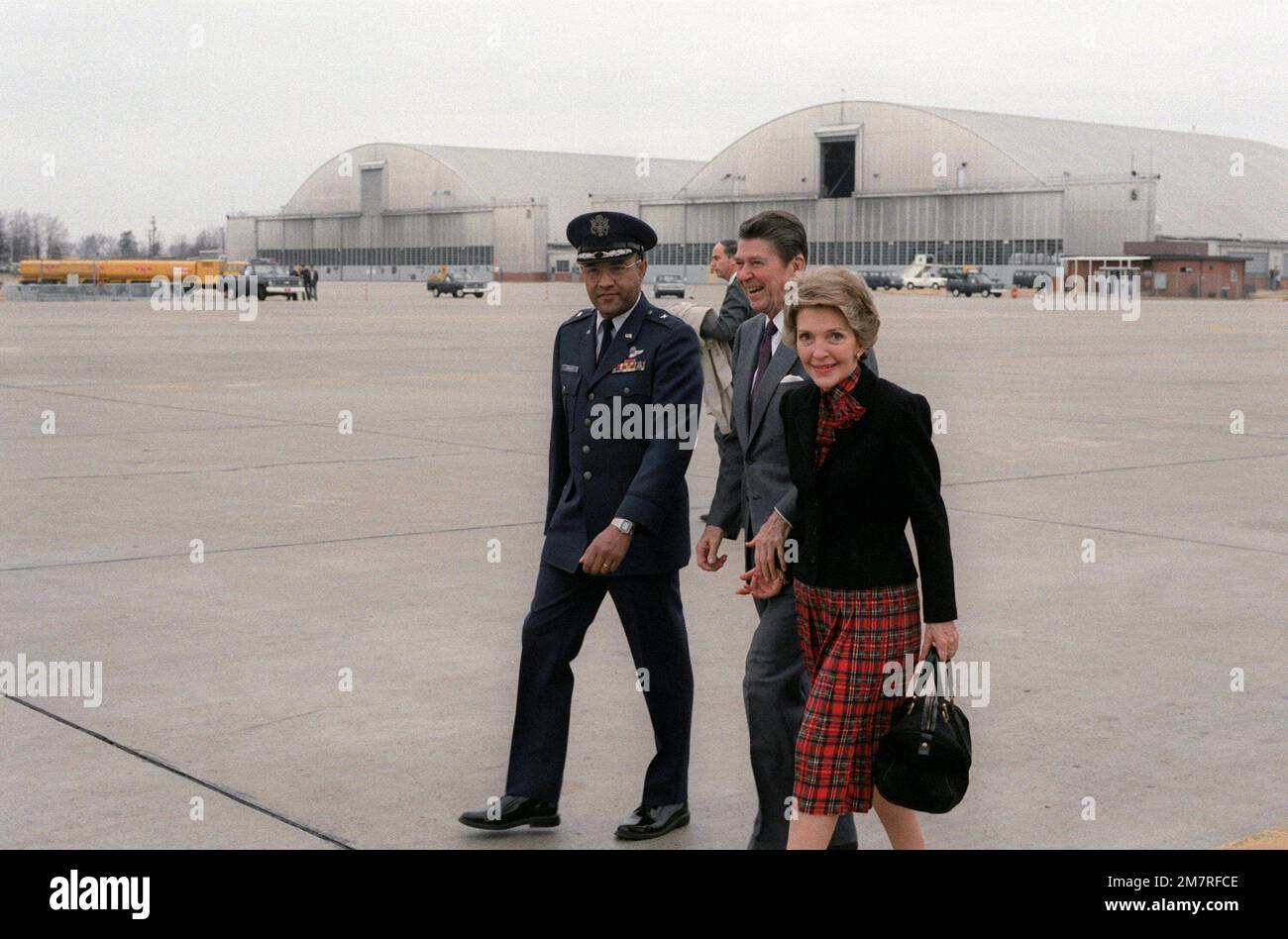 President Ronald Reagan and his wife Nancy walk across the apron as ...