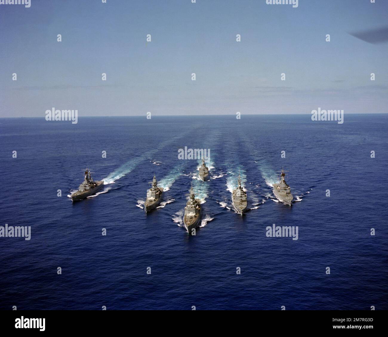 An aerial bow view of six nuclear-powered guided missile cruisers ...